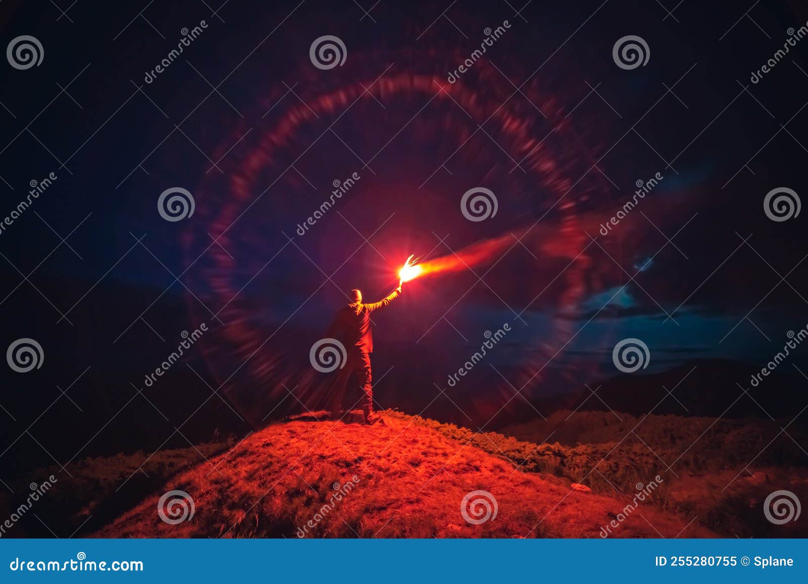 The Man with a Red Firework Stick Standing on a Mountain. Evening Night ...