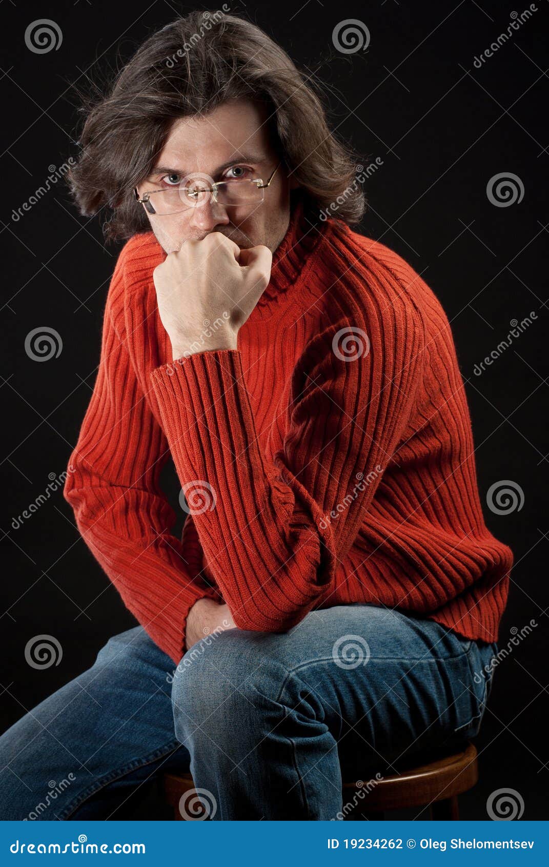 Man in Red Sweater Sitting on Chair Stock Photo - Image of hair, alone ...