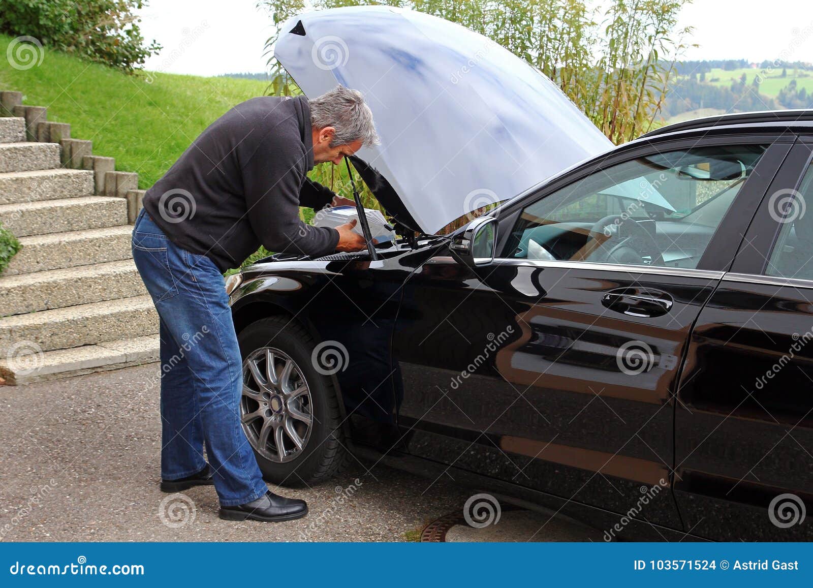 A Man Refills Windscreen Wiping Water on a Car Stock Photo - Image of ...
