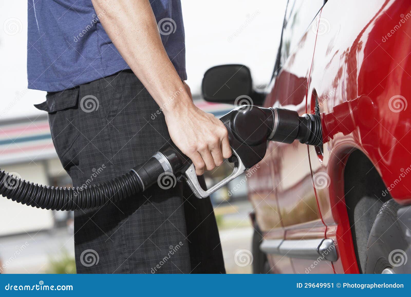 Man Refueling His Car stock image. Image of clothing - 29649951
