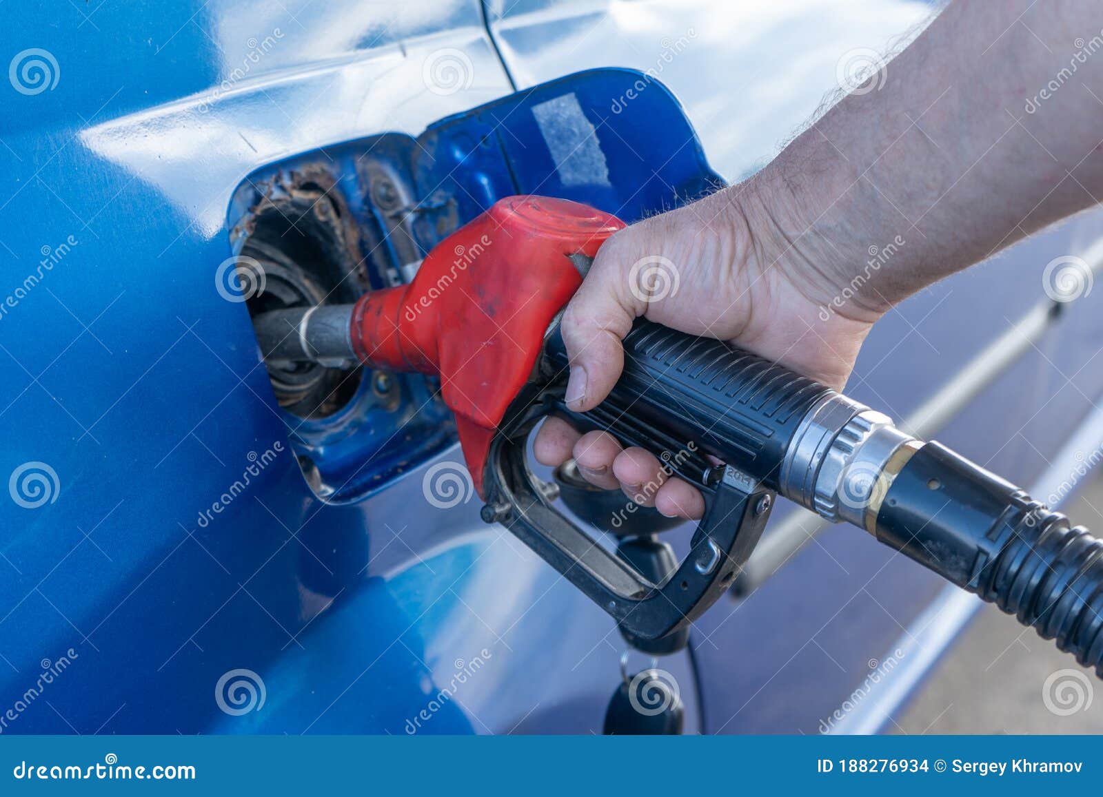 A Man Refuels a Car. Refueling Gun Stock Photo - Image of hand ...