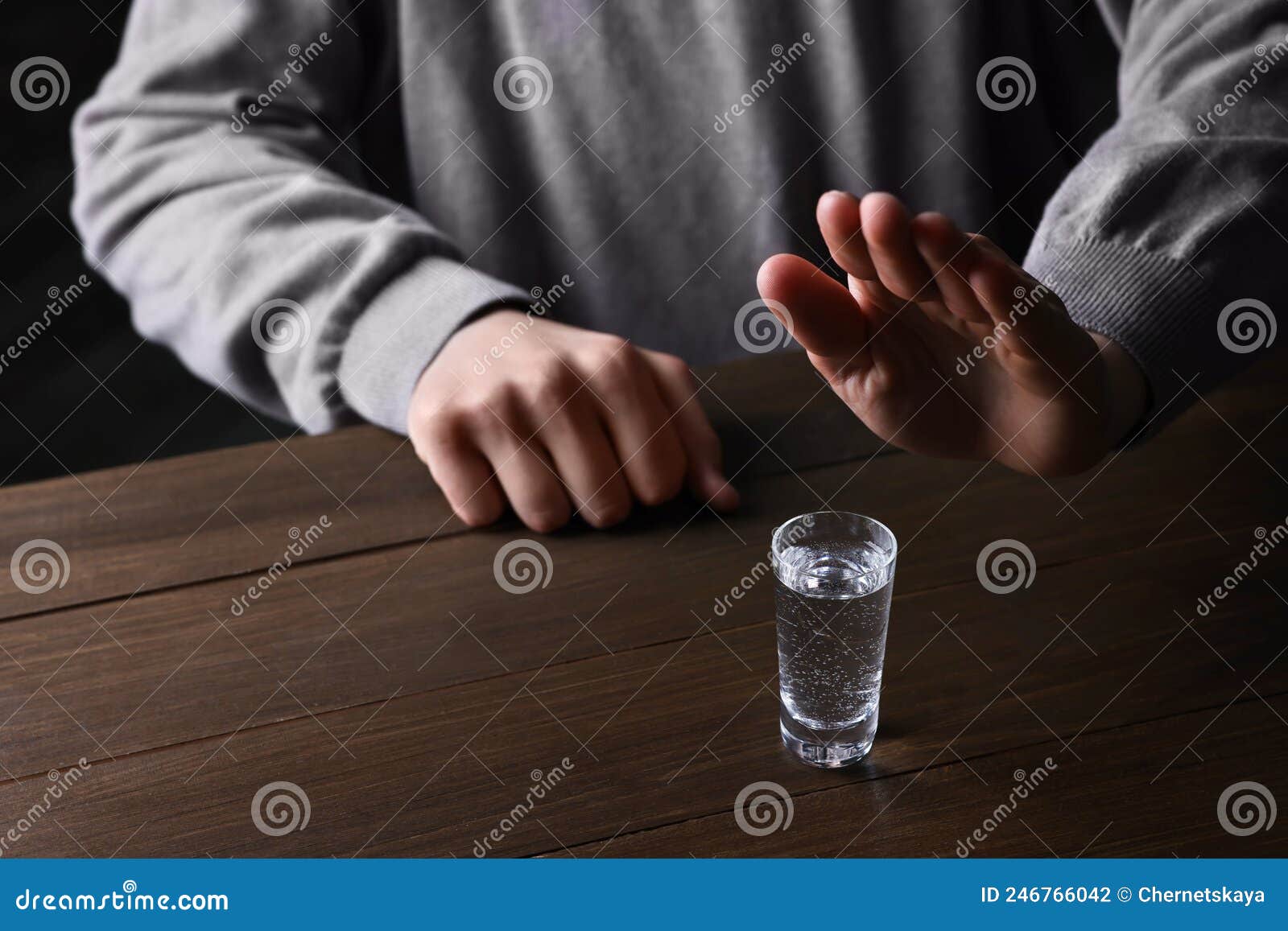 Man Refusing To Drink Vodka at Wooden Table, Closeup. Alcohol Addiction ...