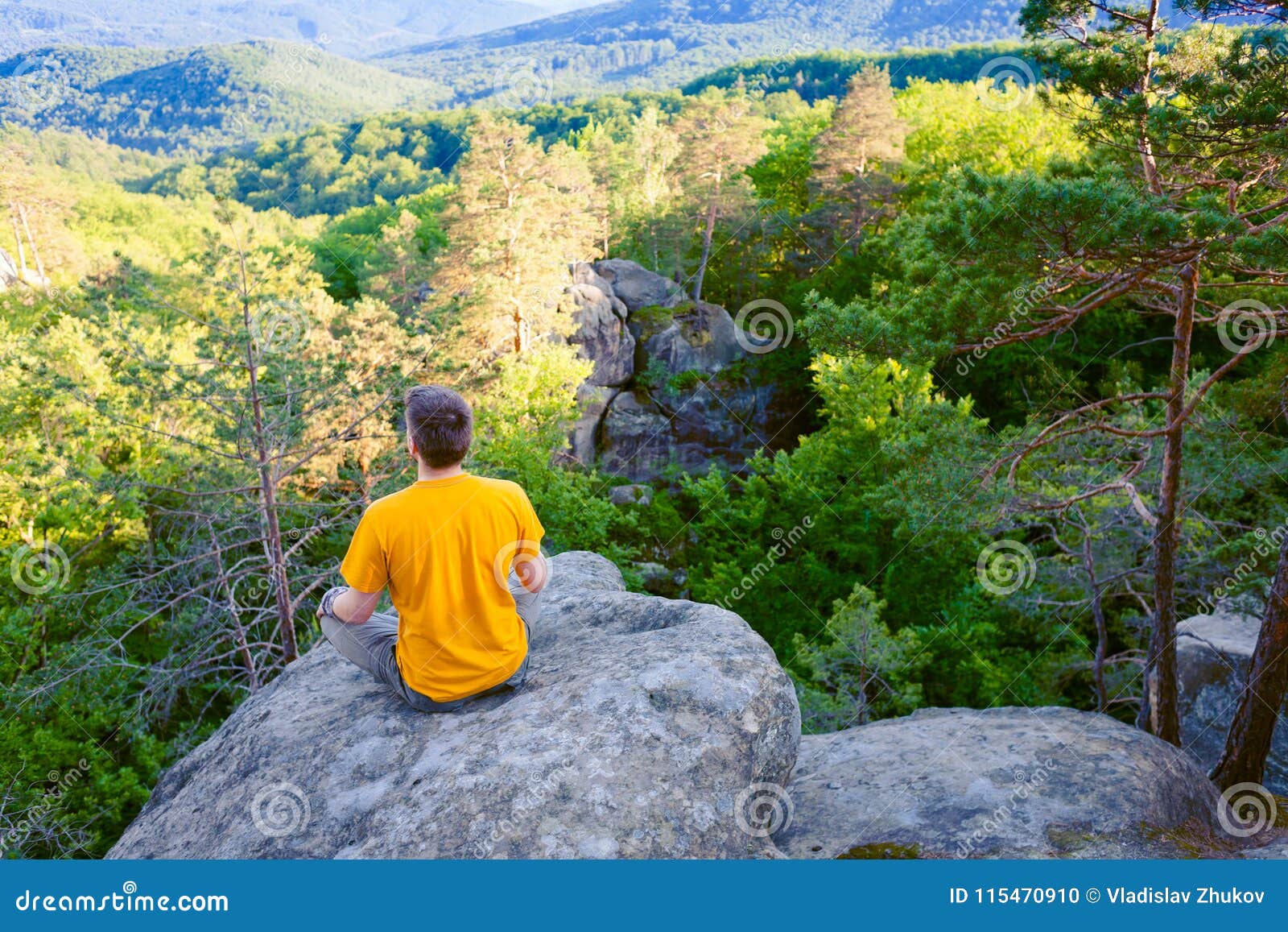 The Man is Sitting on the Mountain. Stock Photo - Image of outdoor ...