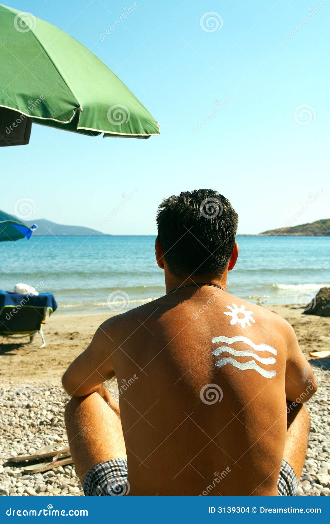 Man relaxing on the beach stock photo. Image of attractive - 3139304