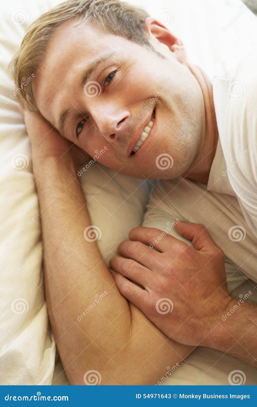 Man Relaxing in Bed stock image. Image of bedclothes - 54971643