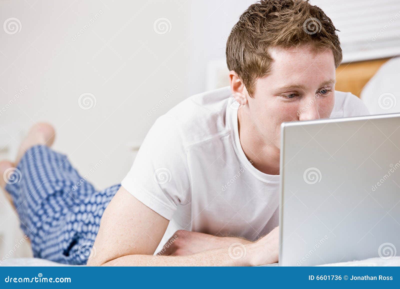 Man Relaxing in Bed Typing on Laptop Stock Photo - Image of people ...