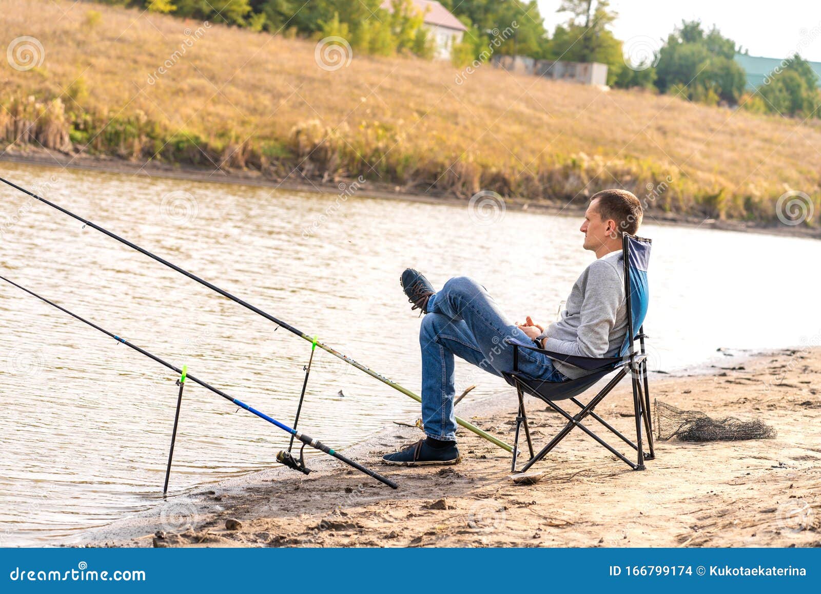 A Man Relaxing and Fishing by Lakeside Stock Photo - Image of hobbies ...