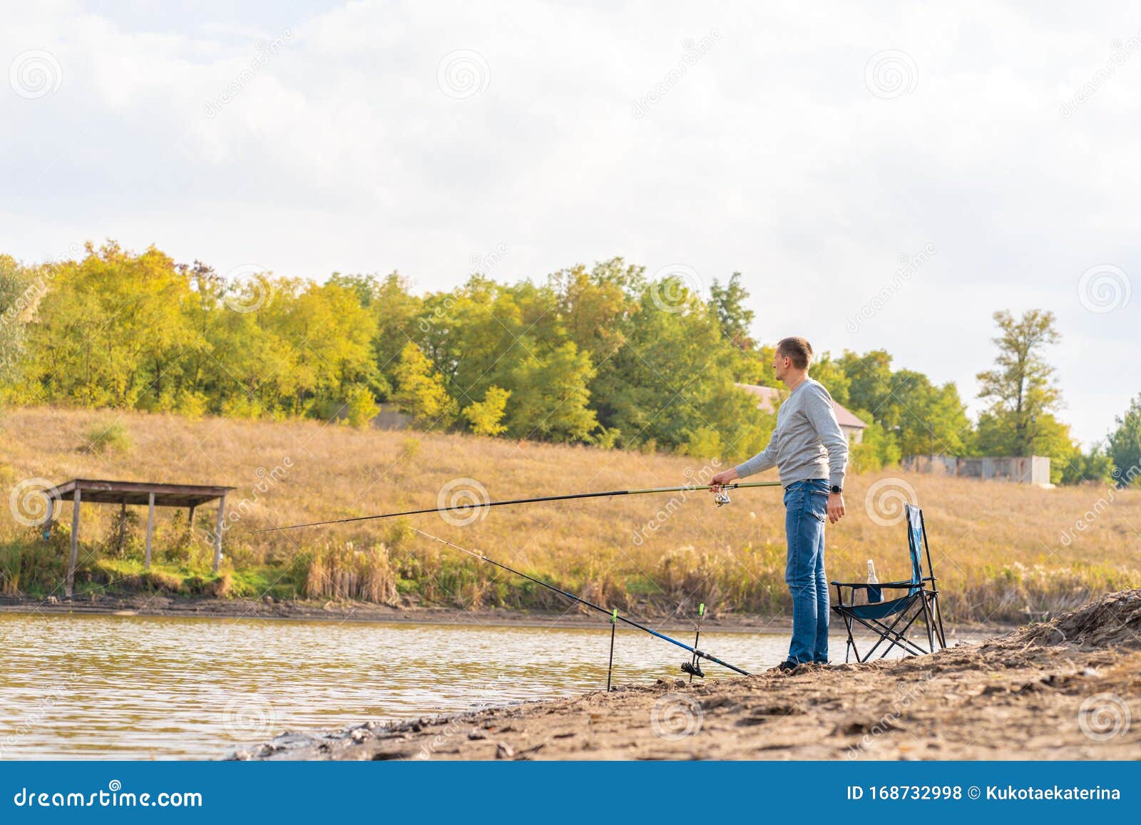Man Relaxing and Fishing by Lakeside a Stock Photo - Image of chair ...