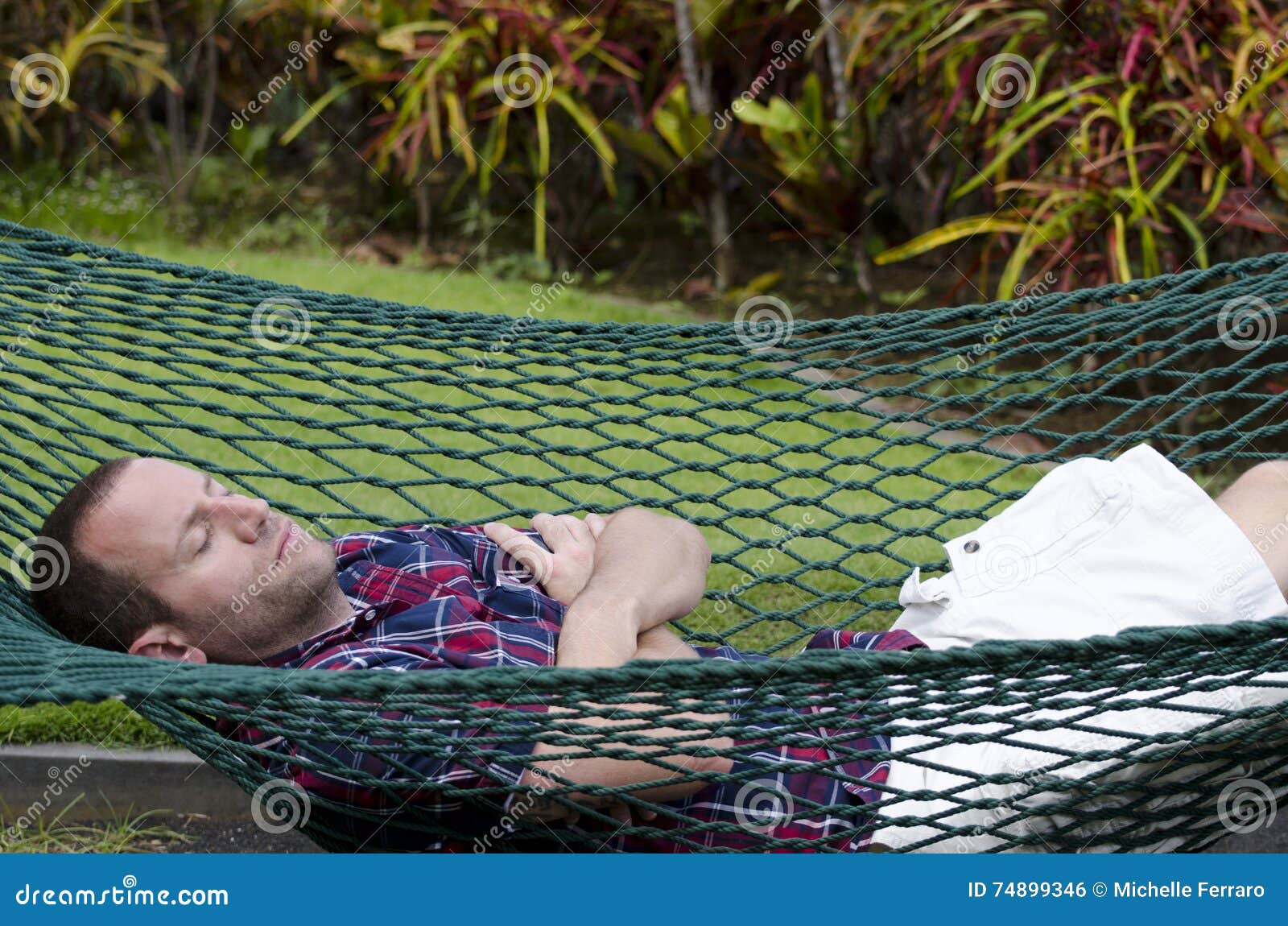 Man relaxing in hammock. stock photo. Image of arms, laying - 74899346