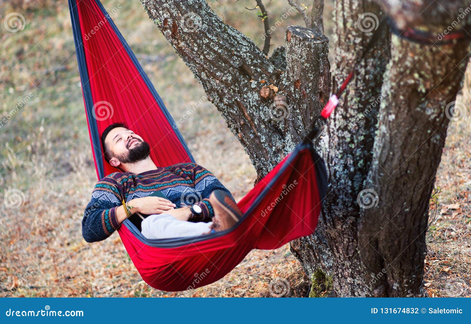 Man relaxing in a hammock stock photo. Image of serene - 131674832
