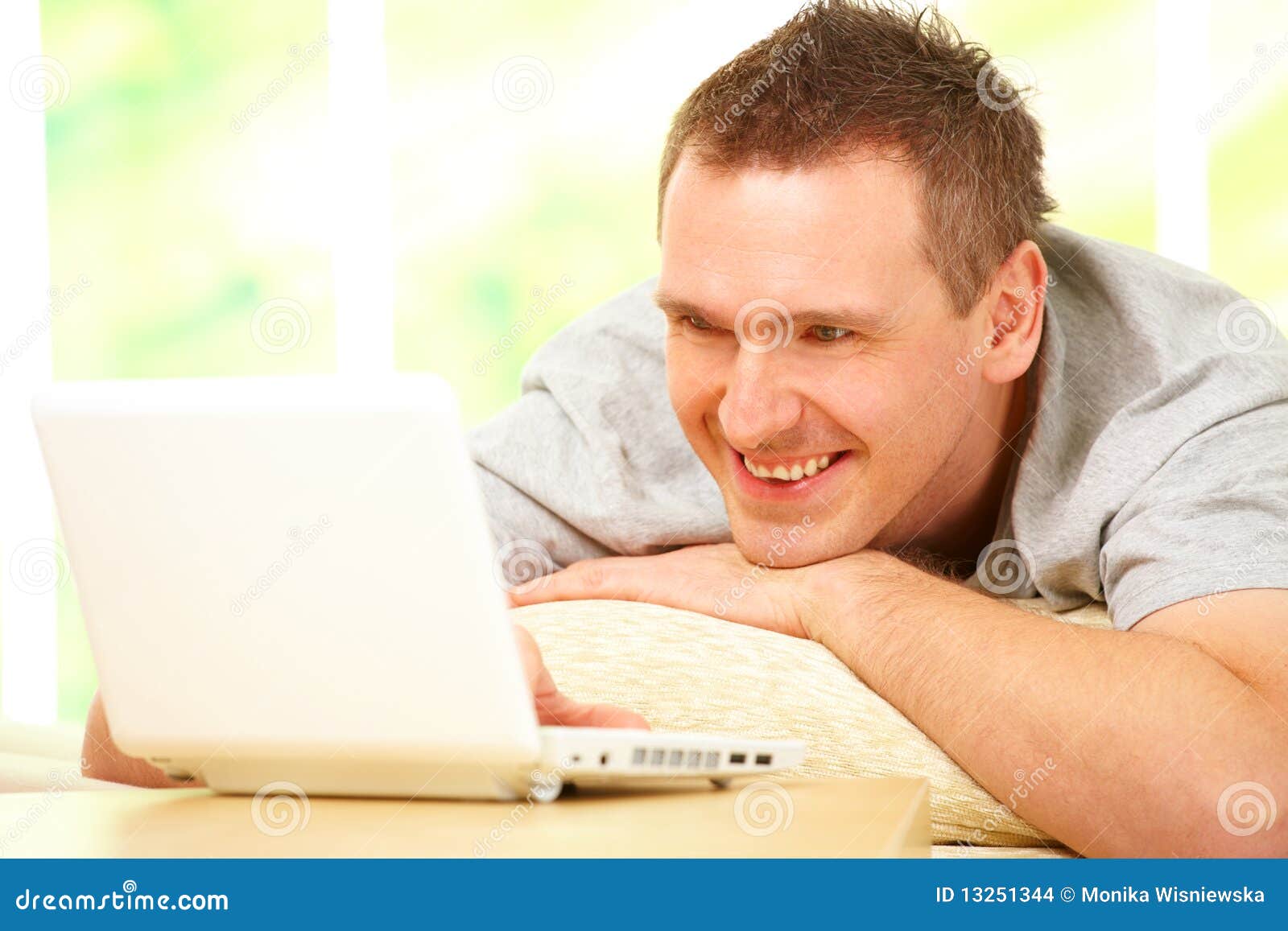 Man relaxing with laptop stock photo. Image of computer - 13251344