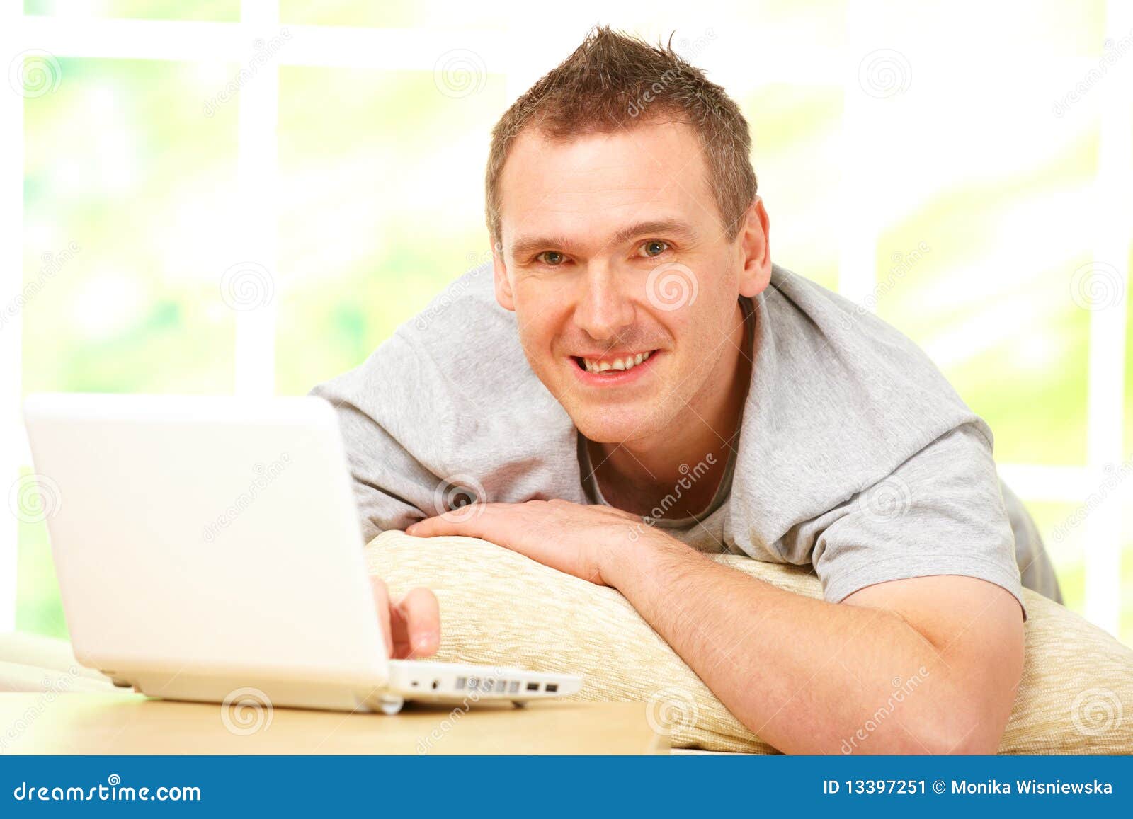 Man relaxing with laptop stock image. Image of cheerful - 13397251