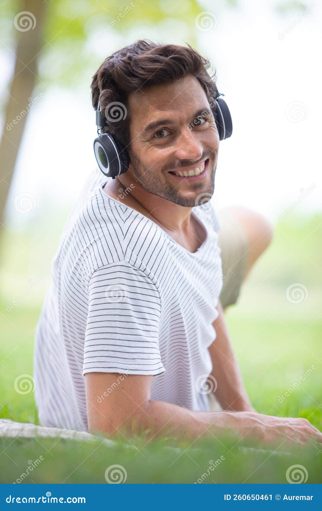 Man Relaxing Listen To Music With Headphones In Park Stock Image