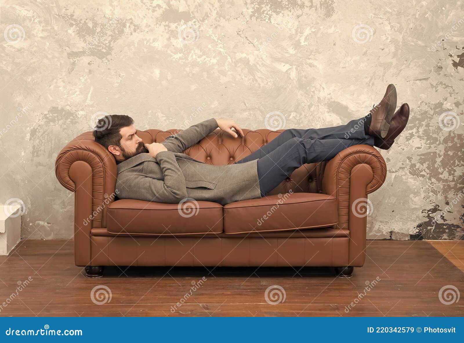 Man Relaxing on Luxurious Leather Couch, Thoughtful Mood Concept Stock ...
