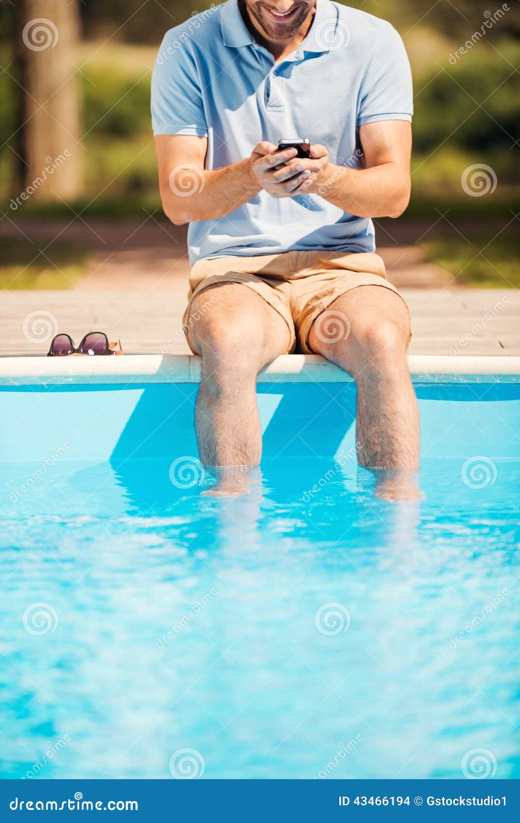 Man relaxing poolside. stock photo. Image of adult, phone - 43466194