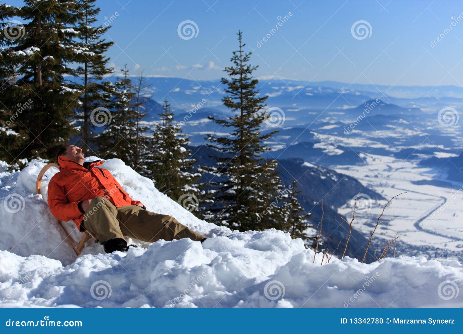 Man relaxing in snow stock photo. Image of travel, toboggan - 13342780