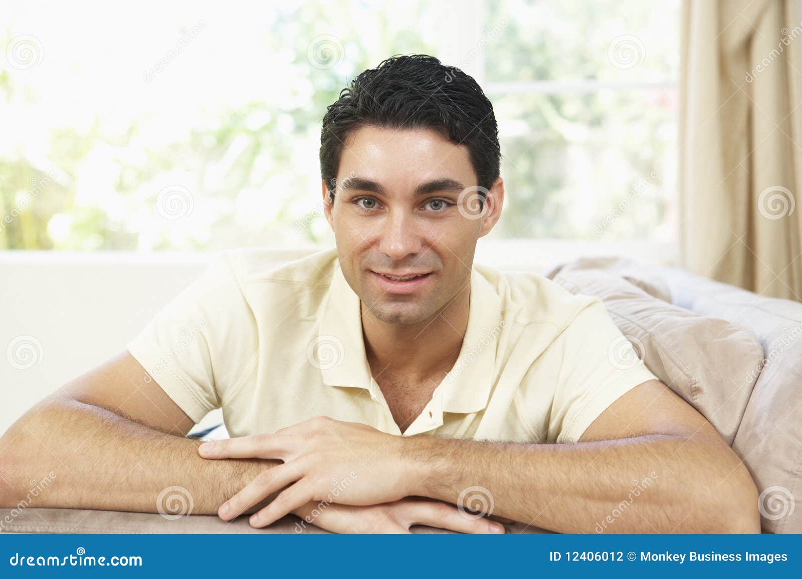 Man Relaxing on Sofa at Home Stock Photo - Image of portrait, three ...