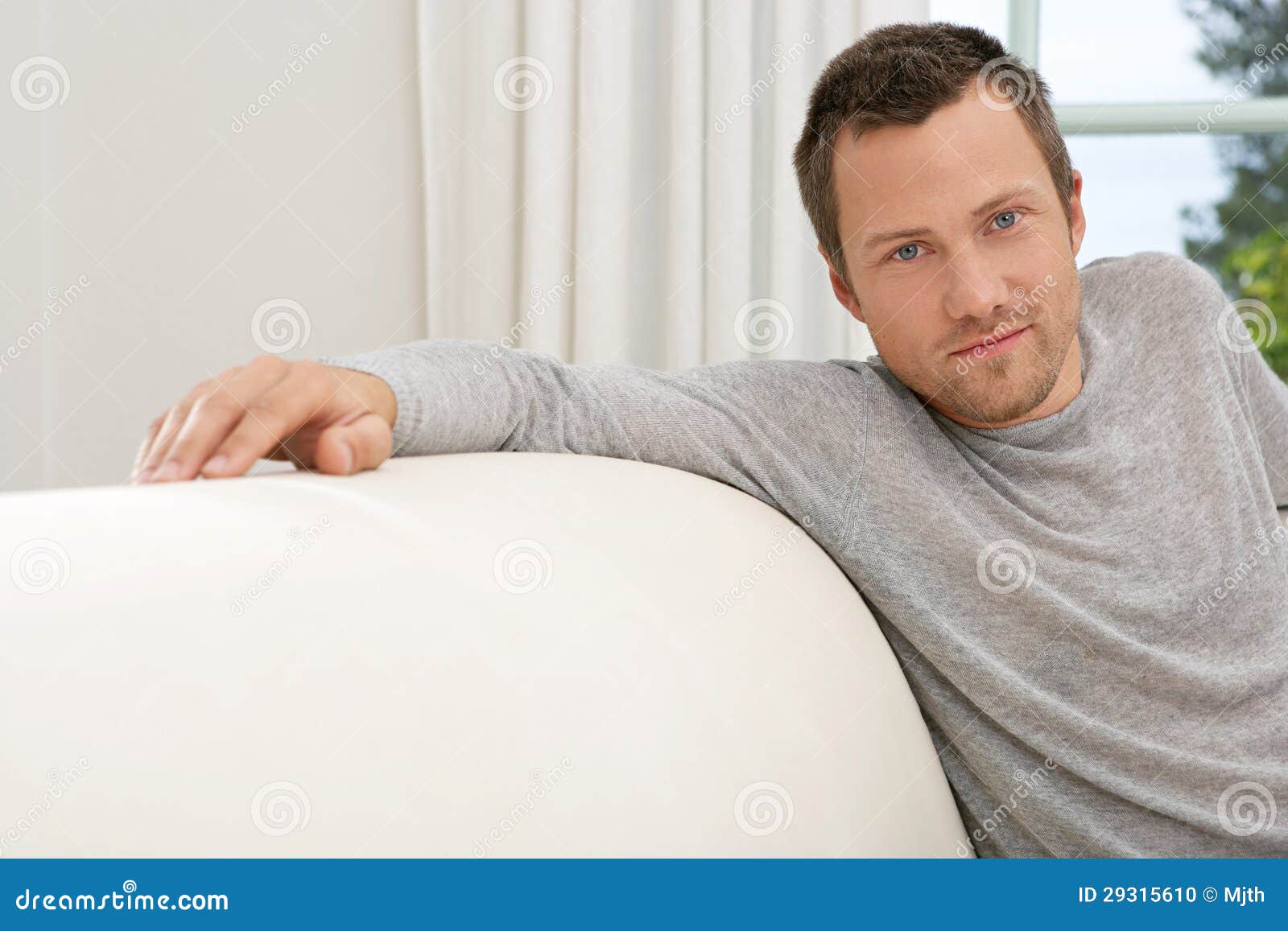 Man Relaxing on Sofa at Home. Stock Photo - Image of professional ...