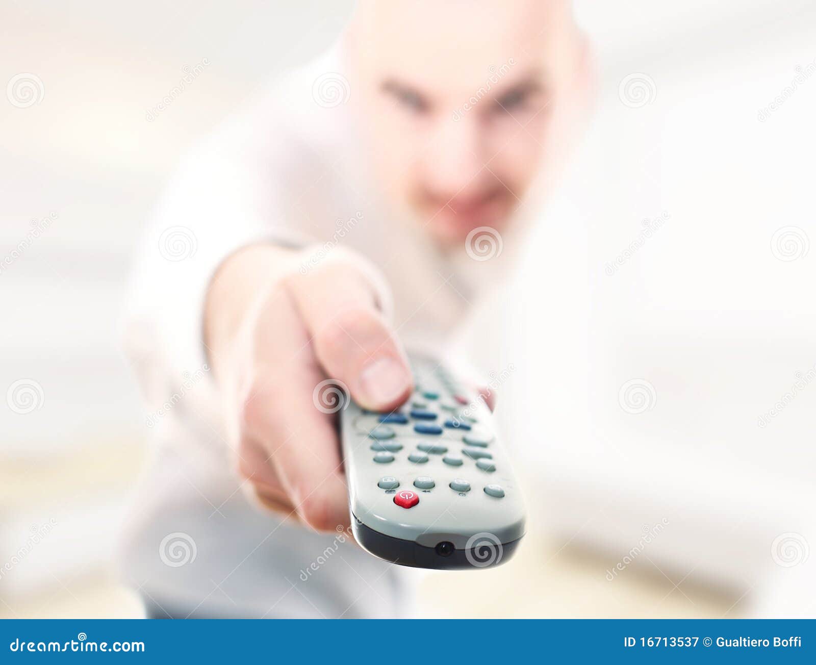 Man with remote control stock image. Image of device - 16713537
