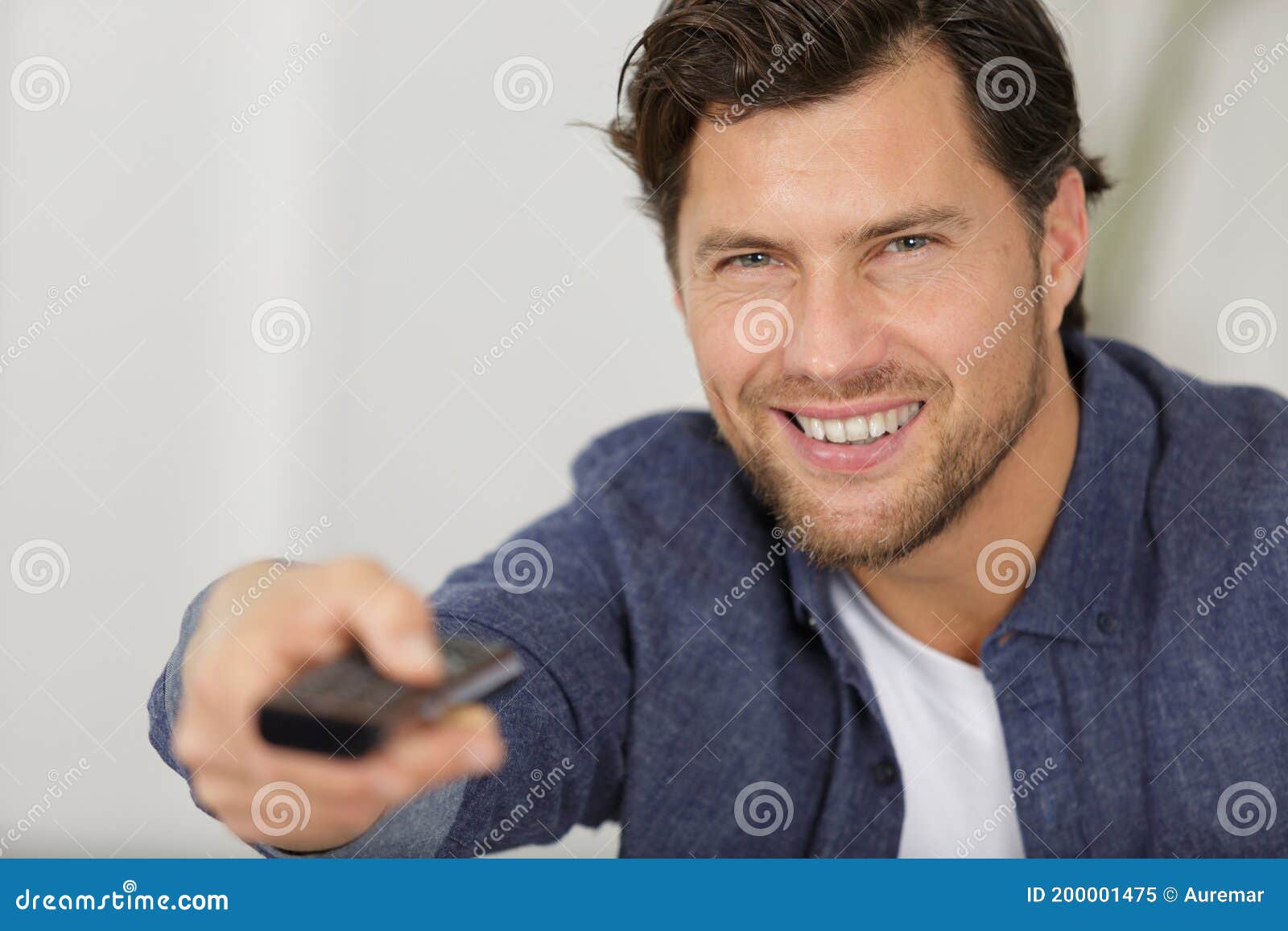 Man with remote control stock image. Image of midadult - 200001475
