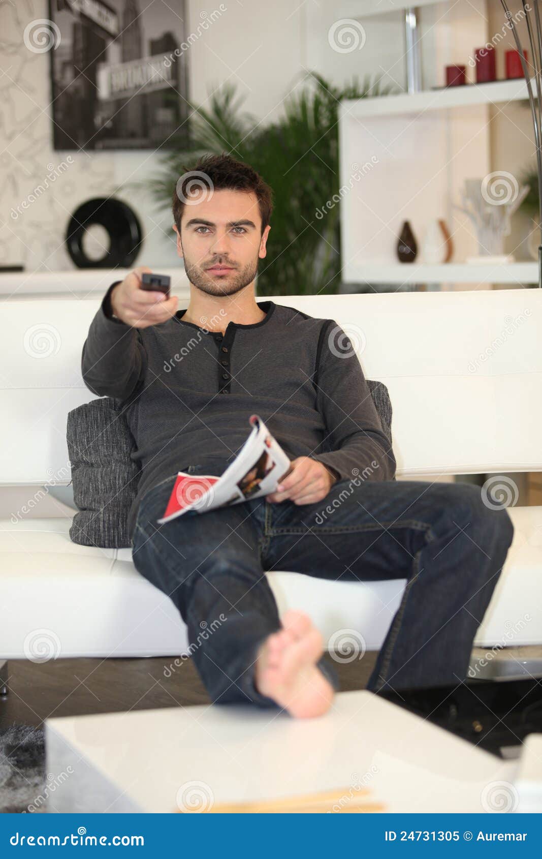 Man with remote control stock image. Image of available - 24731305
