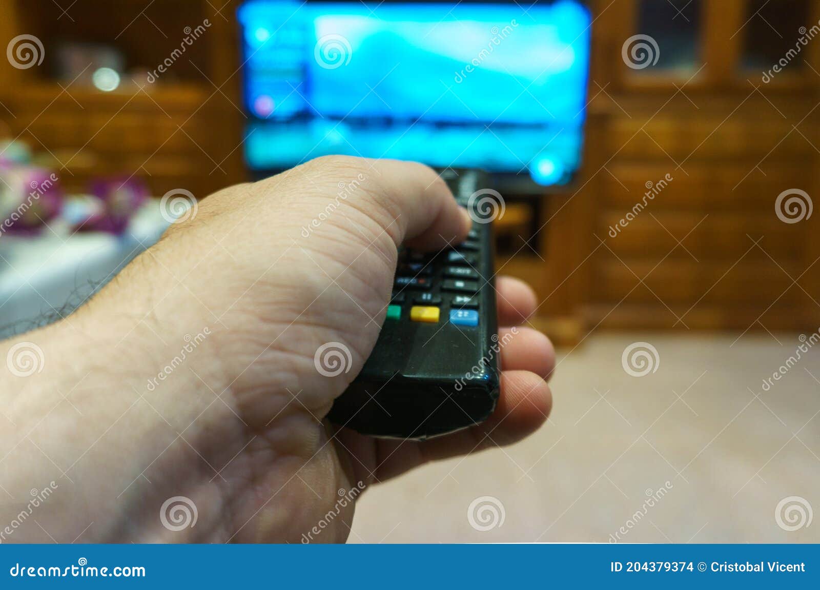 Man with a Remote Control Changing the TV Program. Stock Photo - Image ...