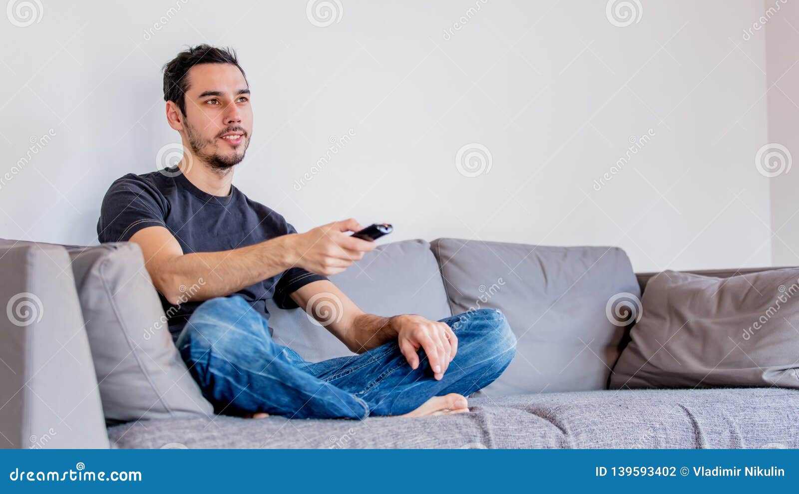 Man with Remote Control on Sofe Watching TV Stock Photo - Image of ...