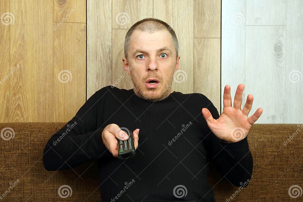 The Man with the Remote Control for the TV in Shock Stares at the ...