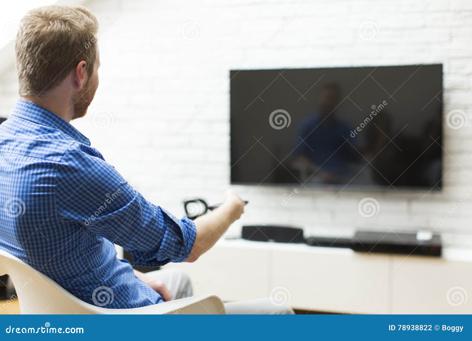 Man with remote control stock photo. Image of casual - 78938822