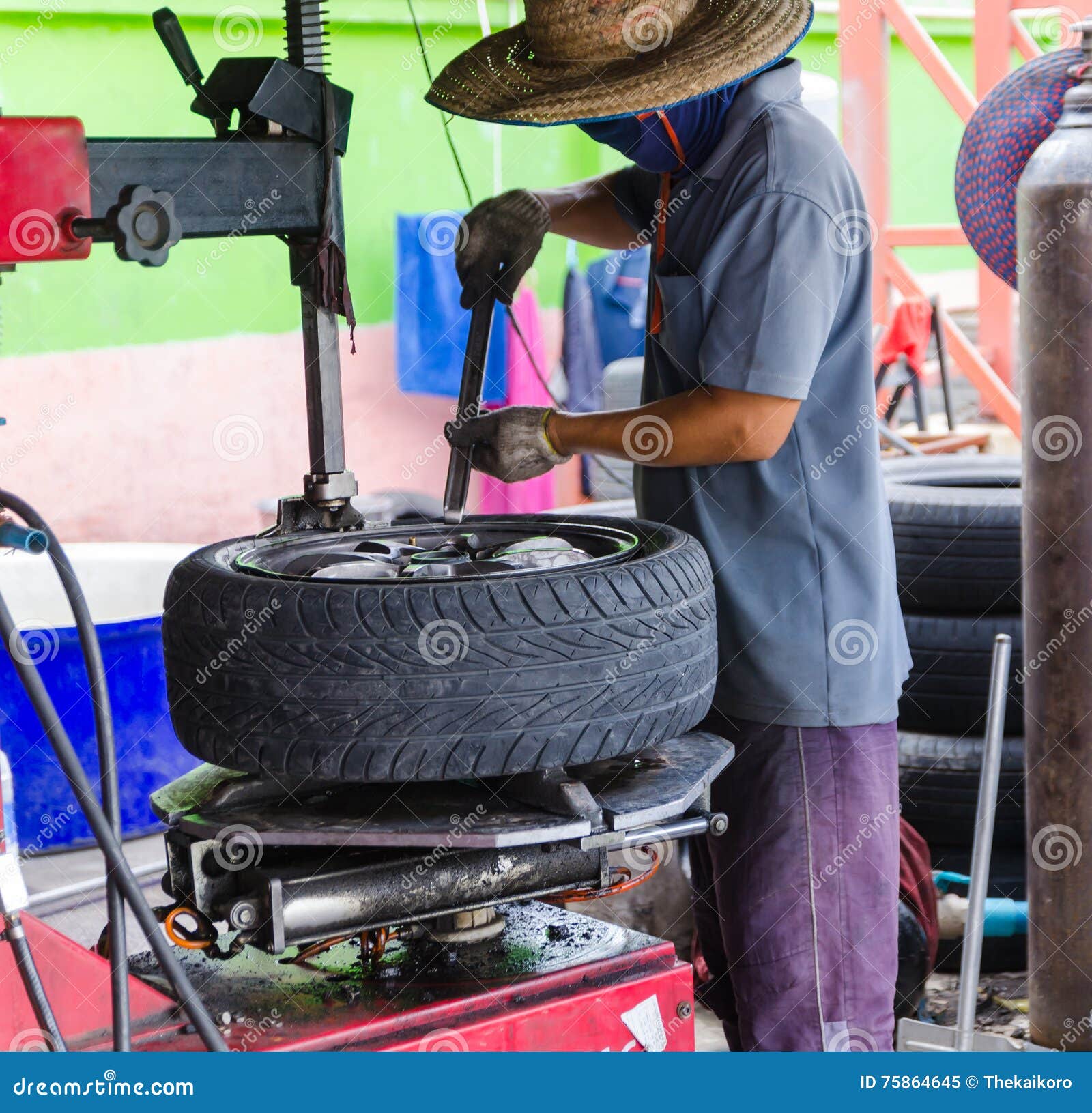 The man removing car tire stock image. Image of troubleshooting - 75864645