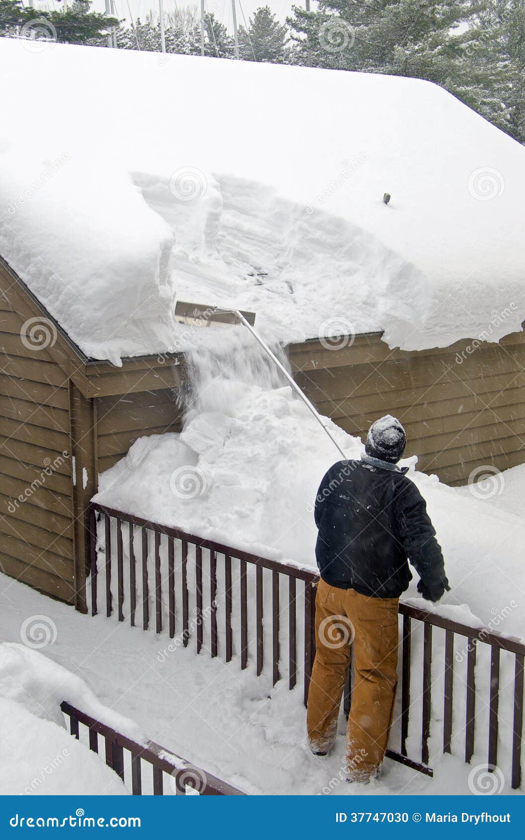 Man Removing Snow from Roof Stock Photo - Image of pile, cold: 37747030