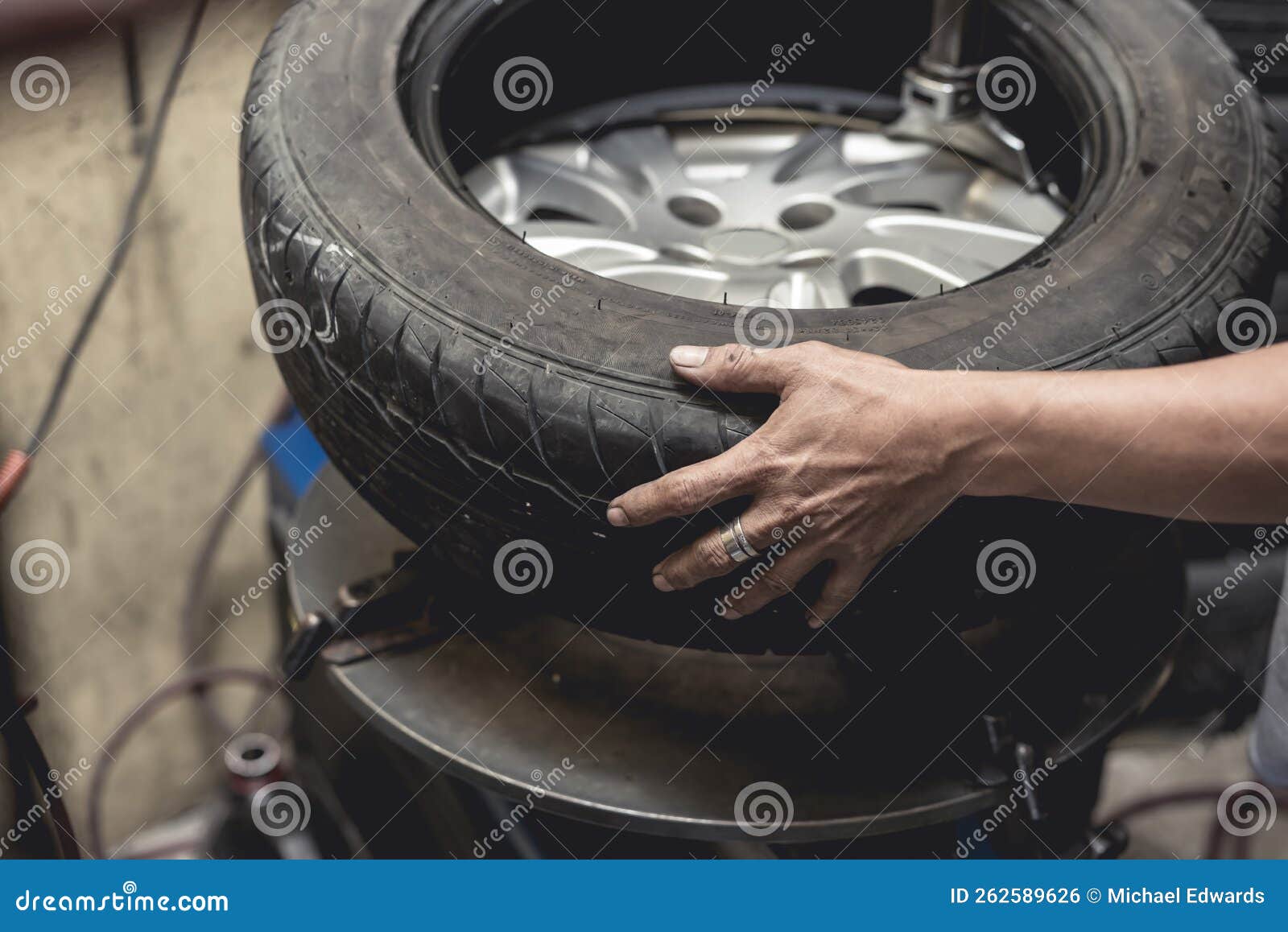 A Man Removing a Tire from the Rim after Using a Tire Bead Breaker at a ...