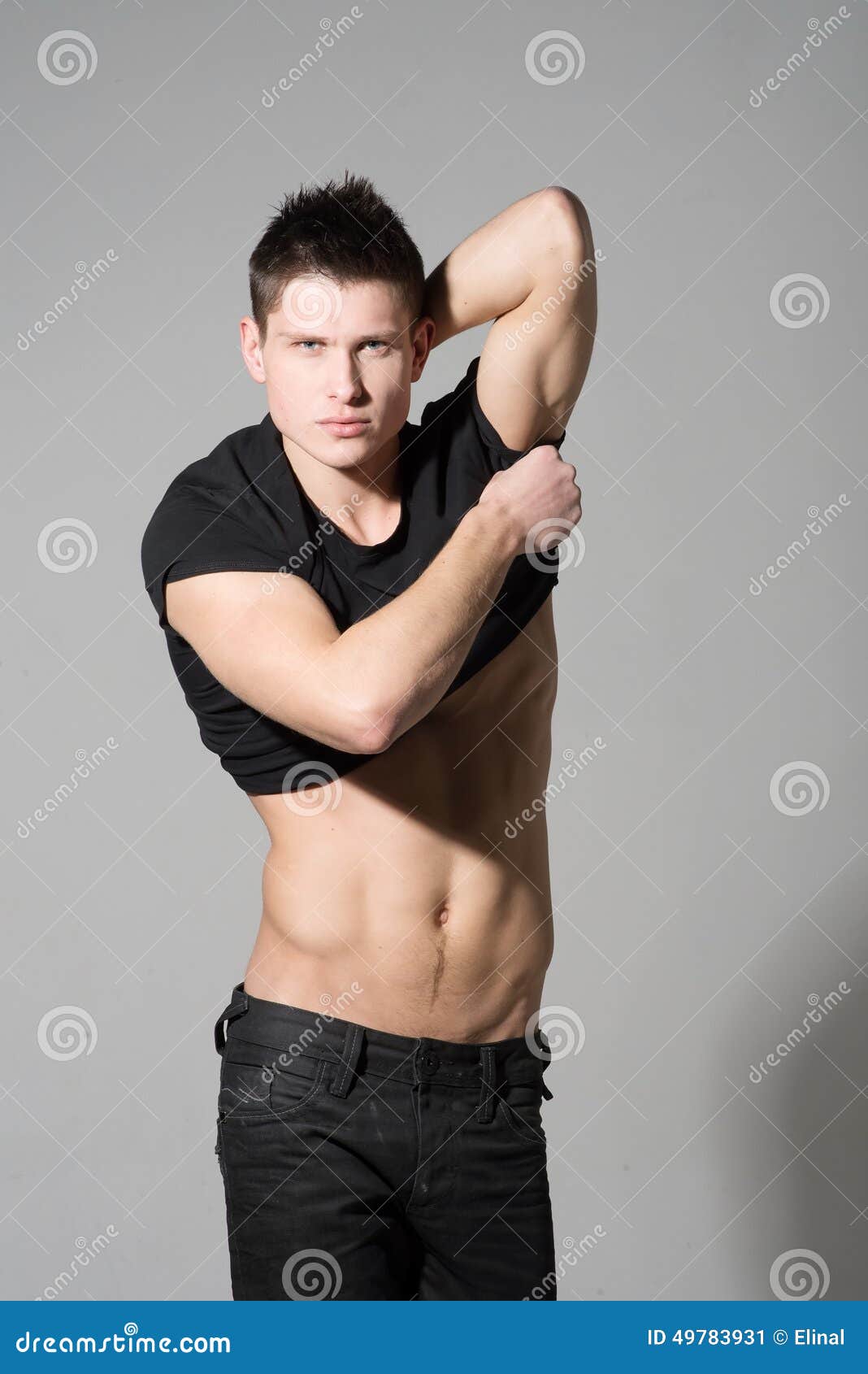 Man Removing Tshirt on Grey Background Stock Image - Image of grey ...