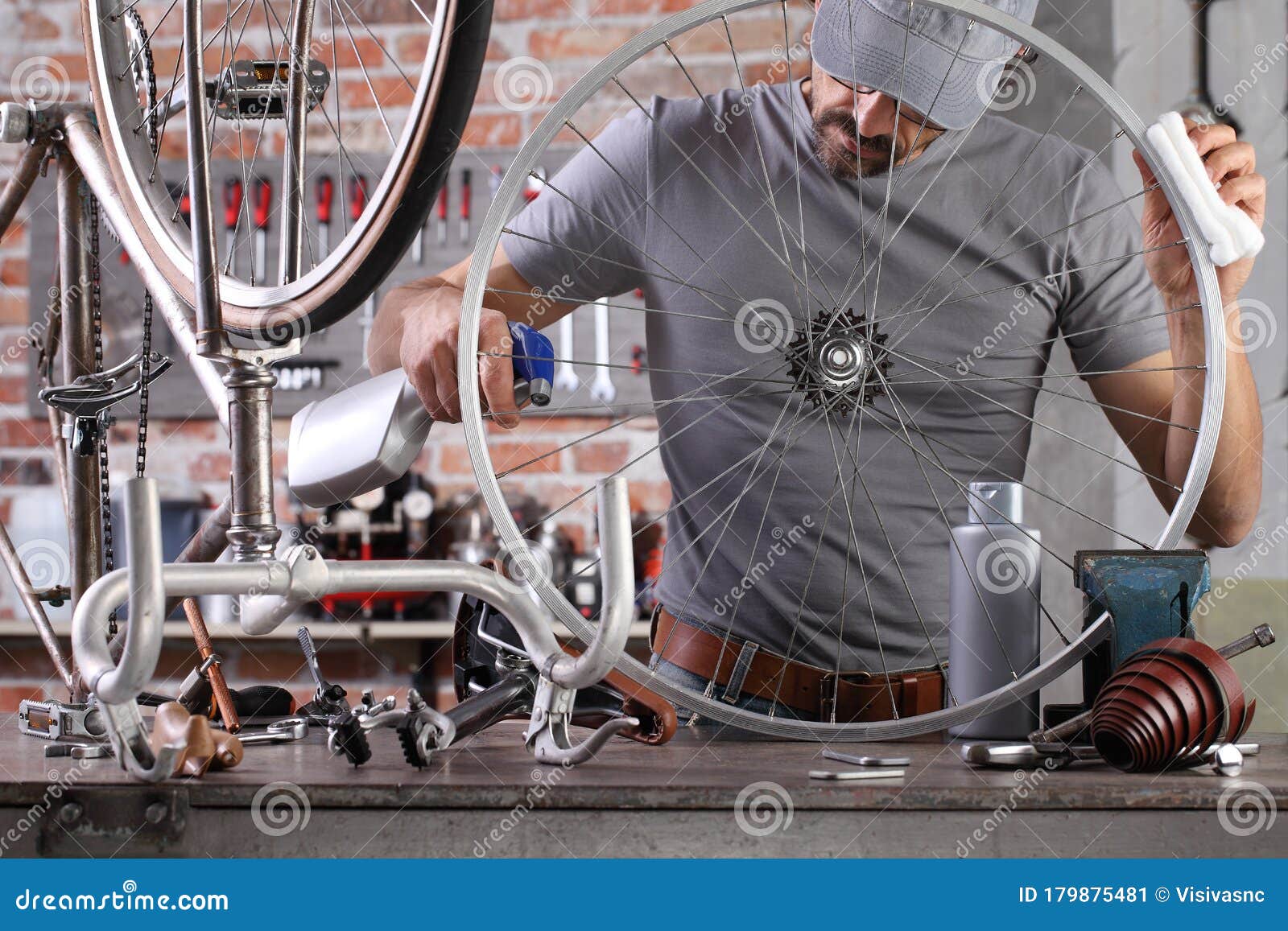 Man Repair the Vintage Bicycle in Garage Workshop on the Workbench with ...