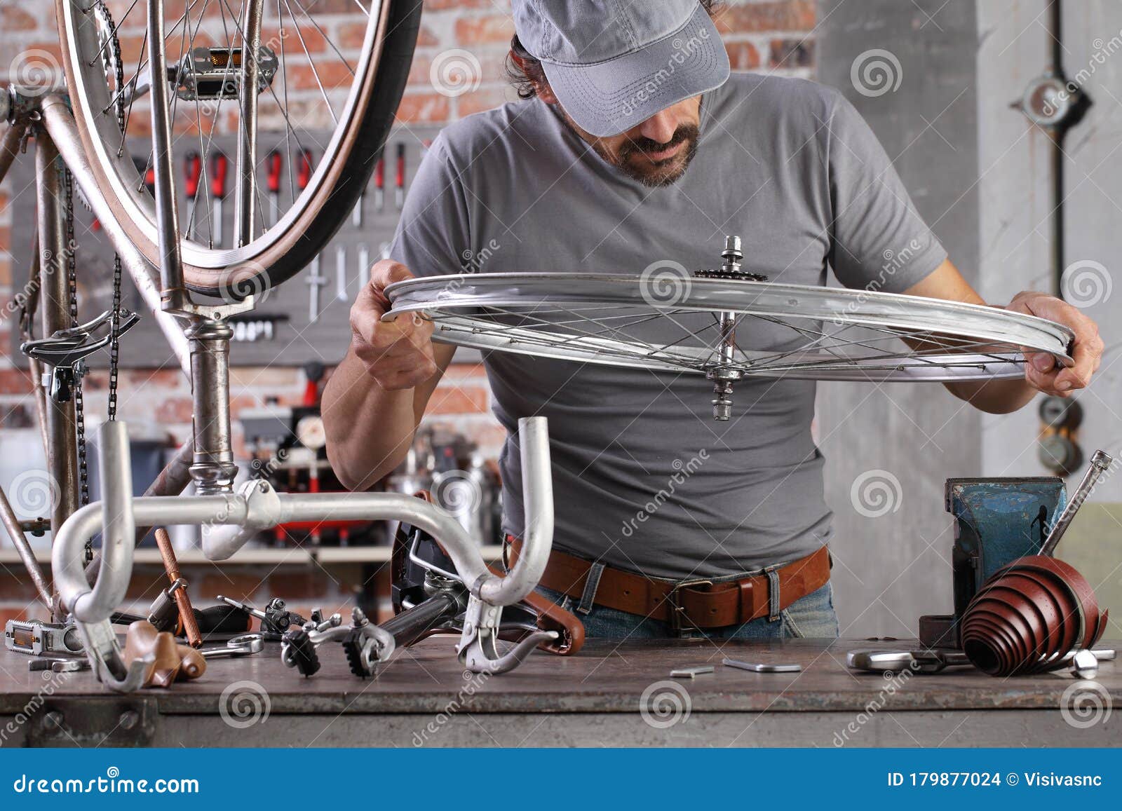 Man Repair the Vintage Bicycle in Garage Workshop on the Workbench with ...