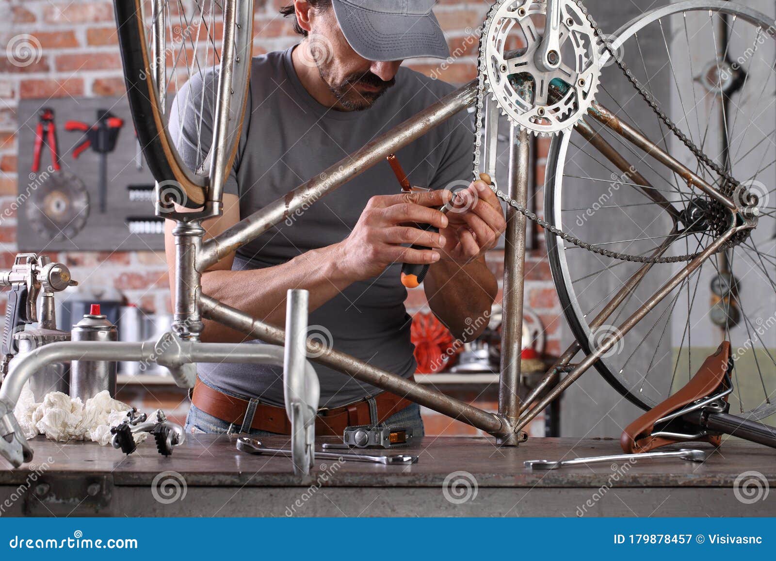 Man Repair the Vintage Bicycle in Garage Workshop on the Workbench with ...