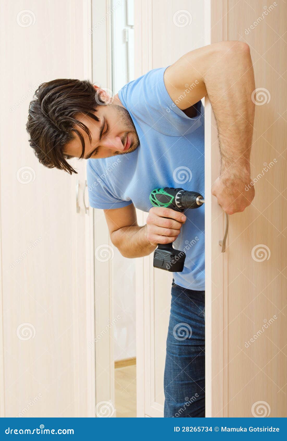 Man repairing stock photo. Image of chiffonier, drill - 28265734