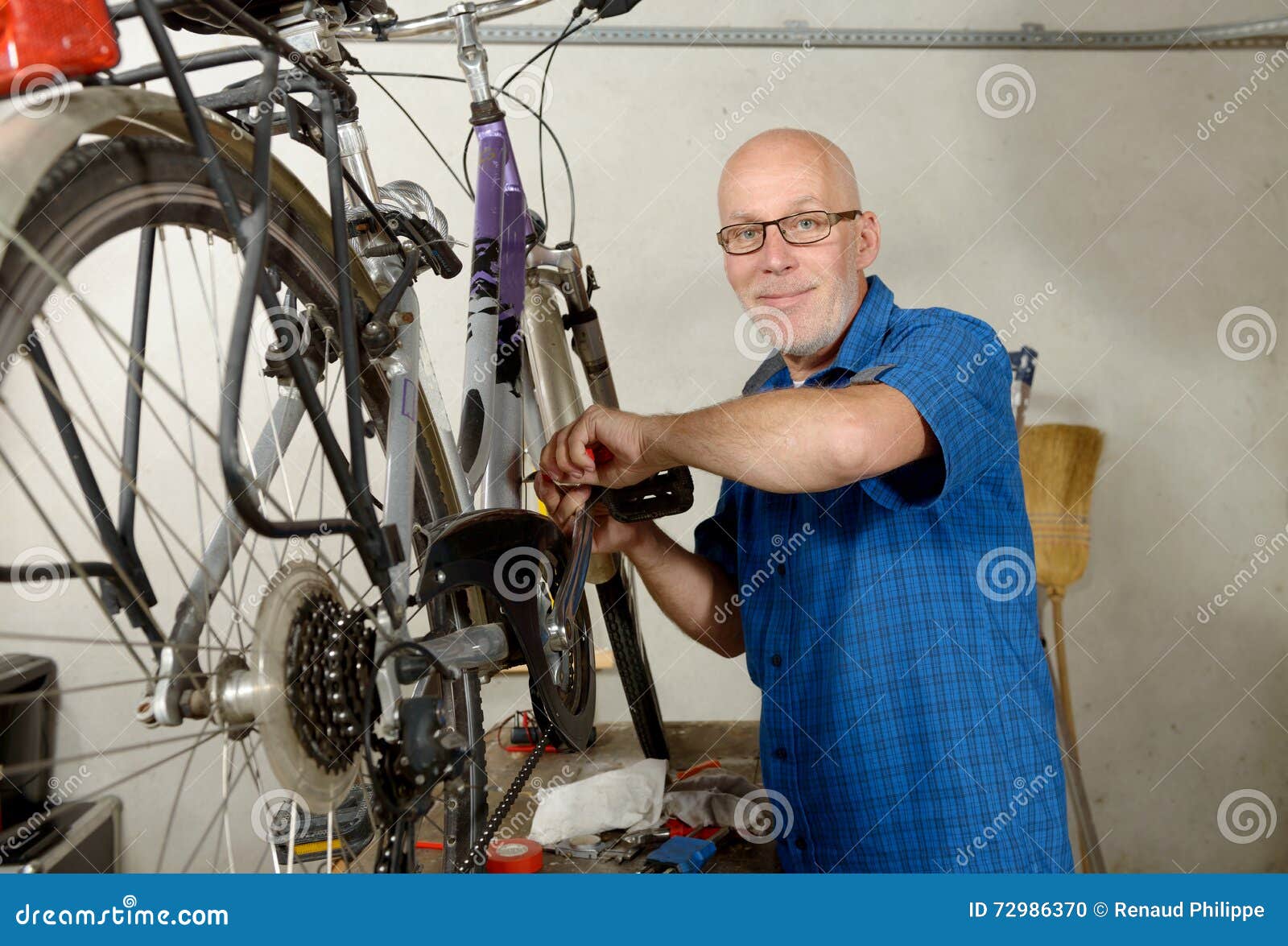 Man Repairing Bicycle in His Workshop. Stock Photo - Image of ...