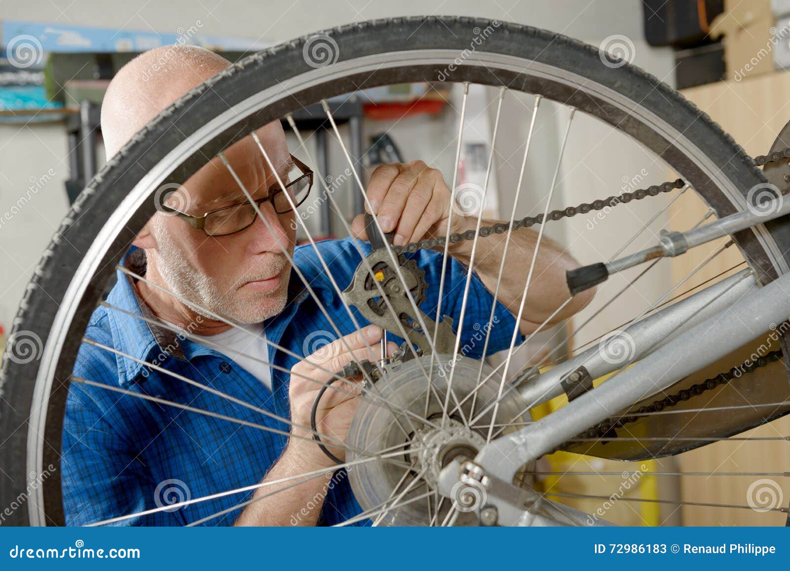 Man Repairing Bike Gear in His Workshop. Stock Image - Image of ...