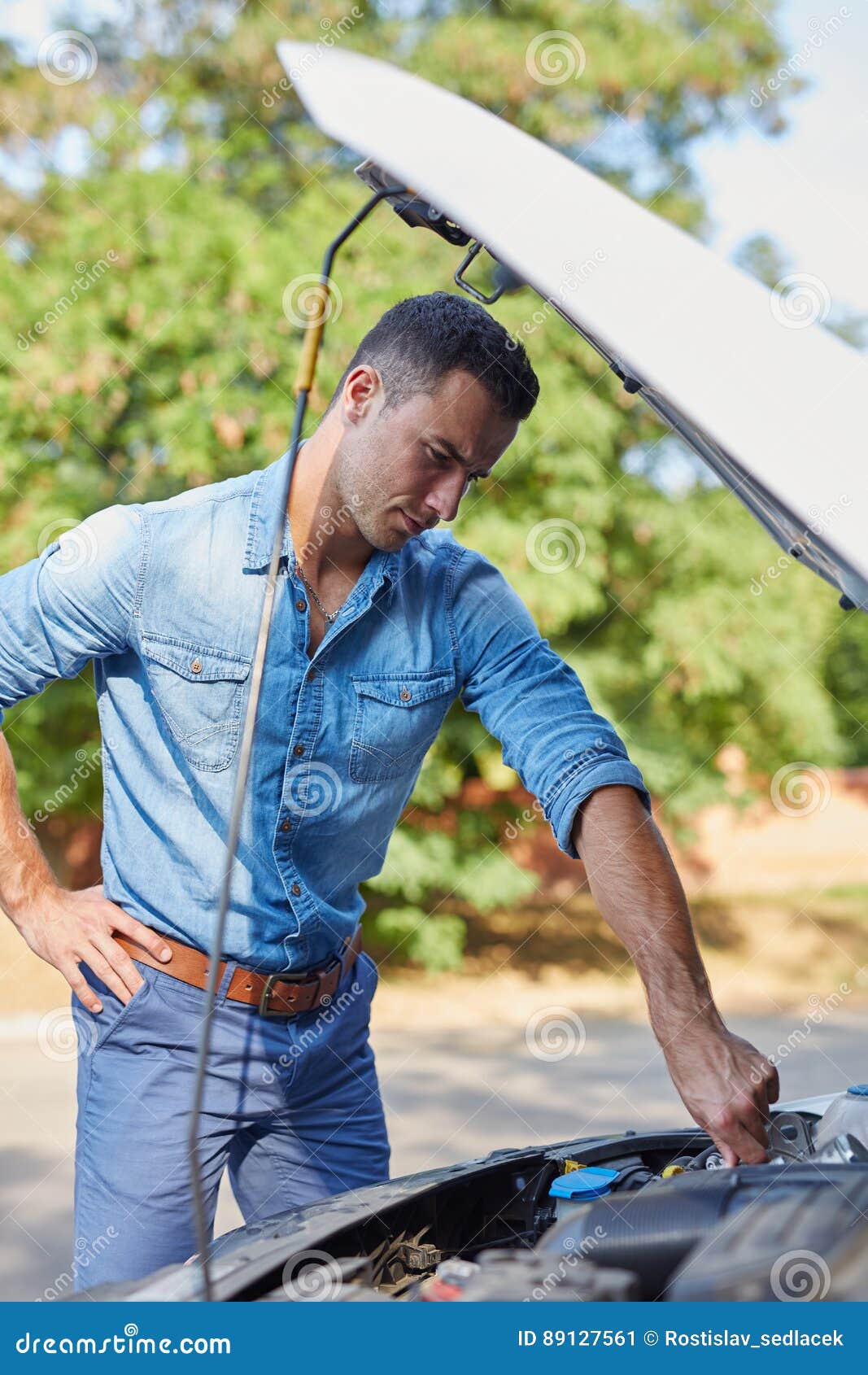 Man repairing a broken car stock image. Image of standing - 89127561