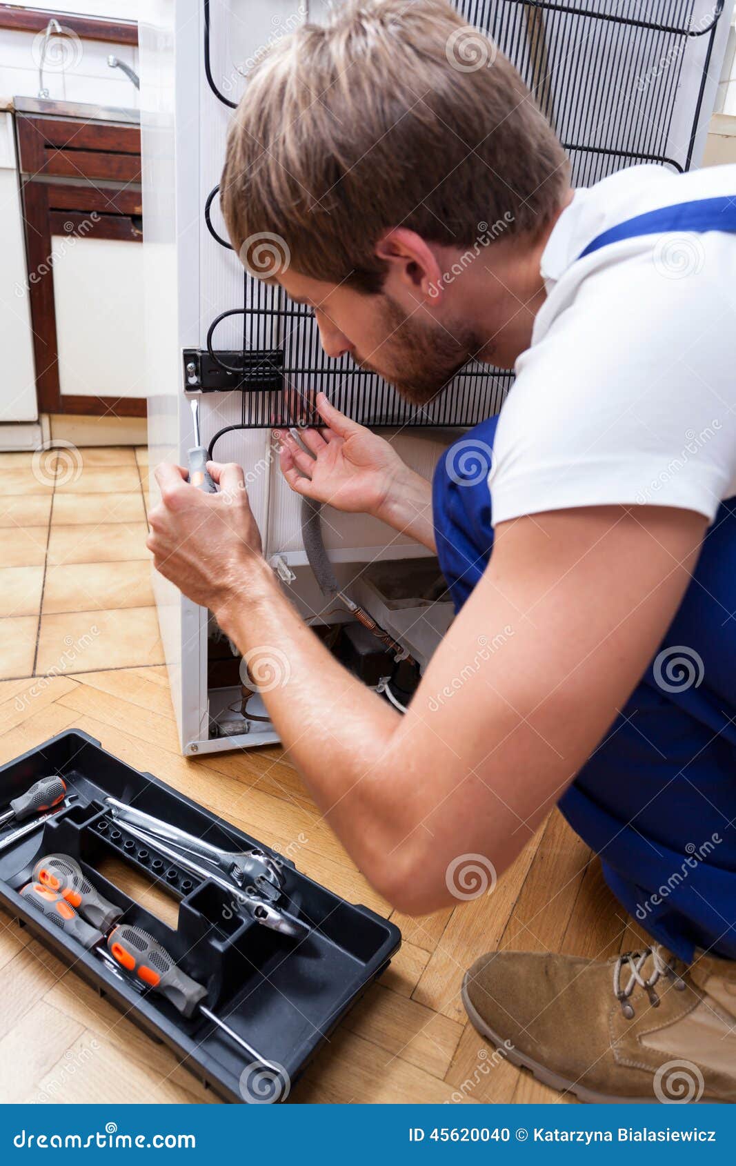 Man Repairing Fridge at Home Stock Photo - Image of construction ...