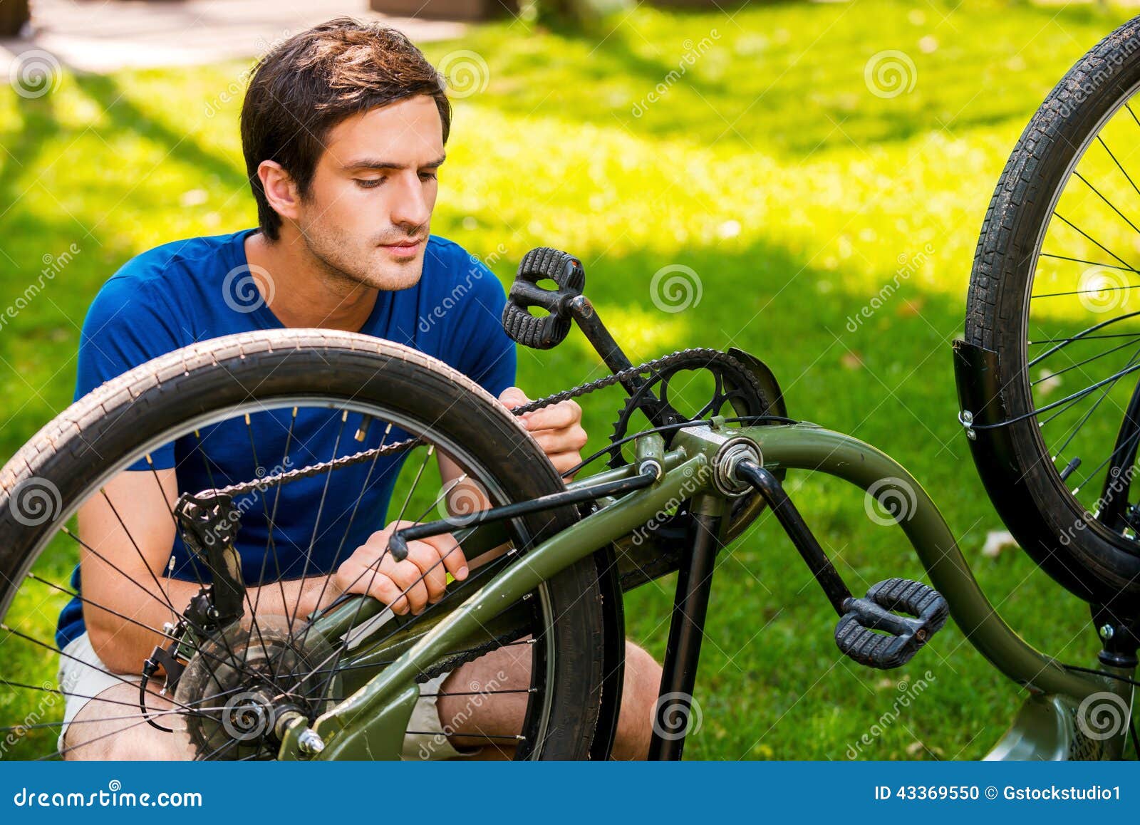 Man repairing his bike. stock photo. Image of beauty - 43369550 Man repairing his bike. stock photo. Image of beauty - 43369550