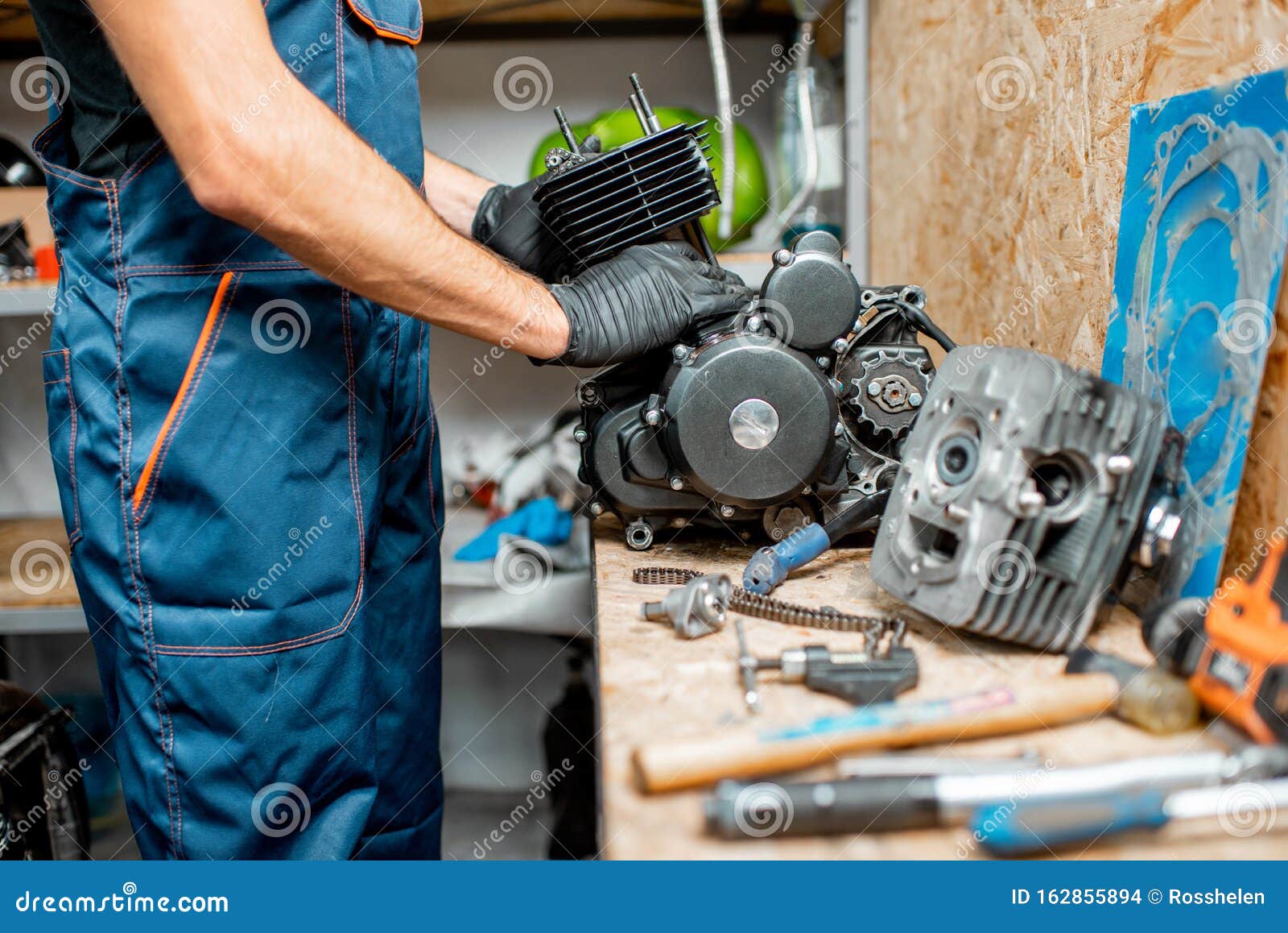 Man Repairing Motorcycle Engine Stock Photo - Image of overalls, table ...