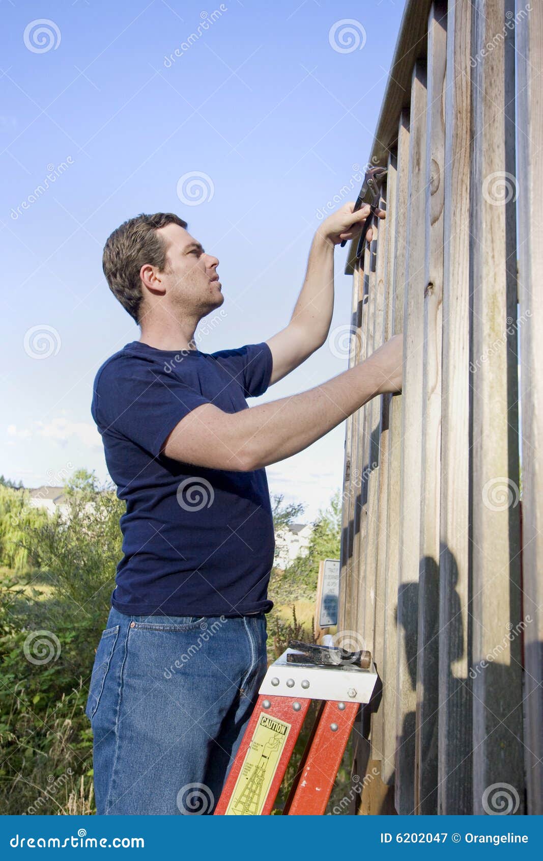 Man Repairing Siding stock image. Image of standing, climbing - 6202047