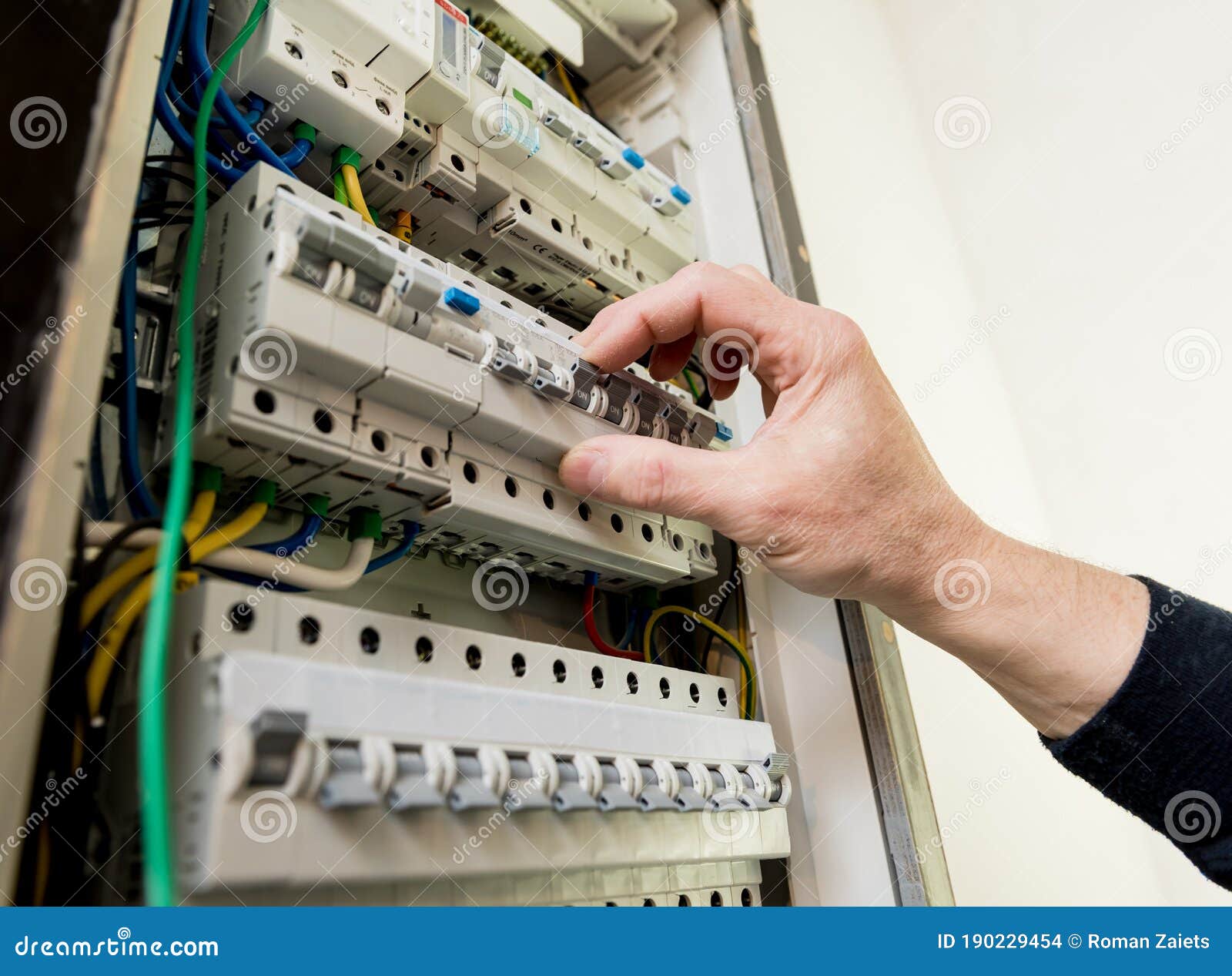 The Man is Repairing the Switchboard Voltage with Automatic Switches ...