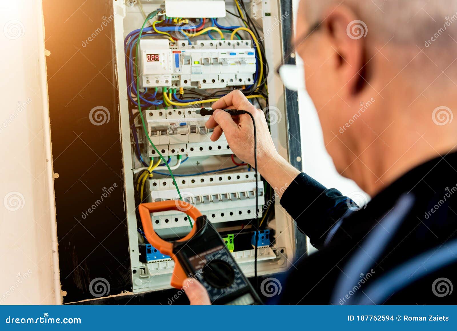 The Man Is Repairing The Switchboard Voltage With Automatic Switches ...