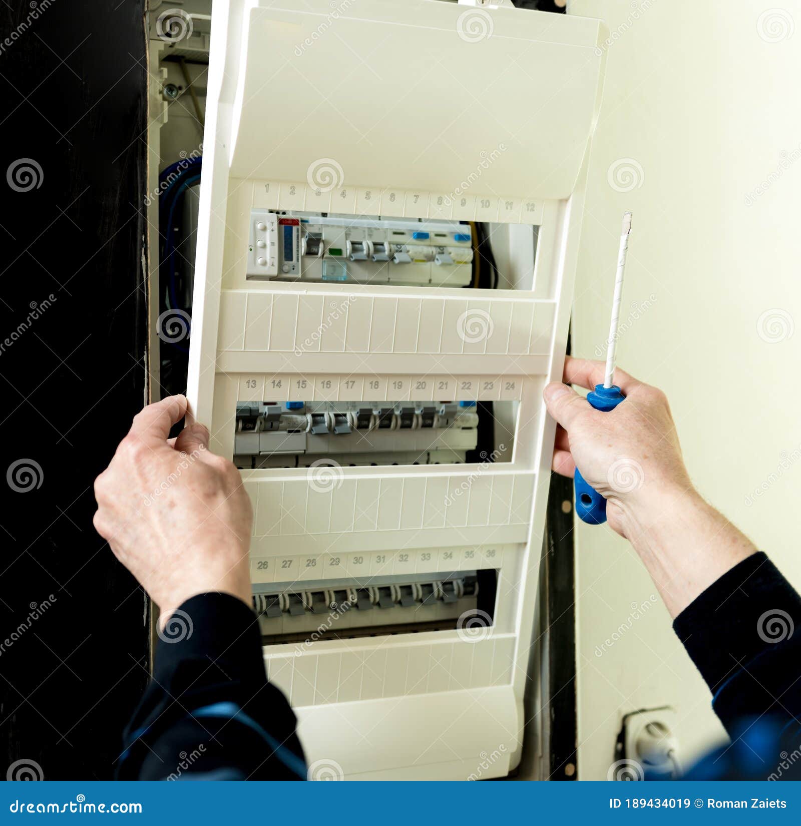 The Man is Repairing the Switchboard Voltage with Automatic Switches ...