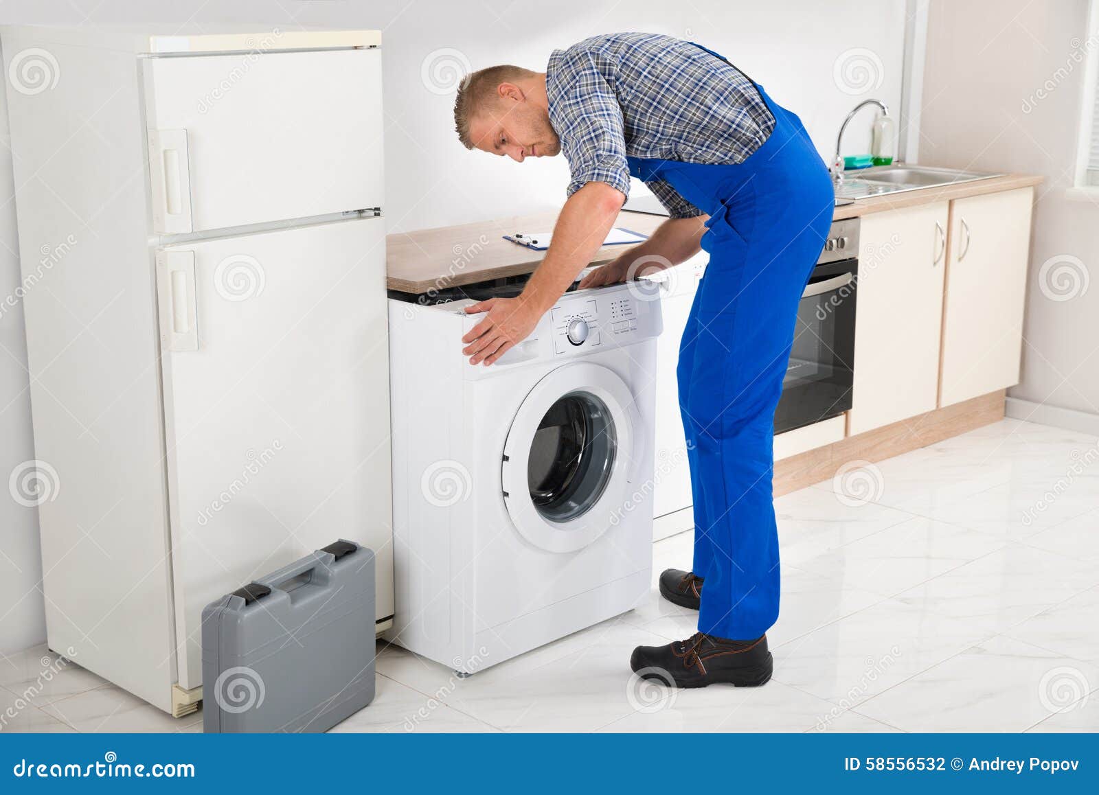 Man Repairing Washing Machine Stock Photo - Image of male, adult: 58556532