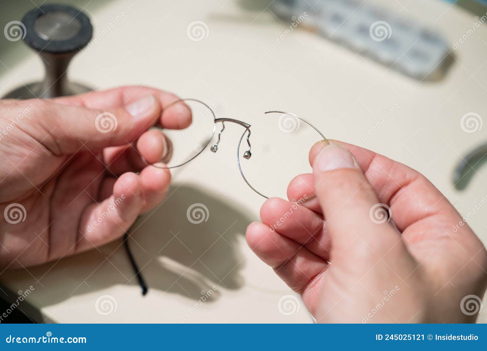 A Man Repairs a Broken Eyeglass Frame. Close-up of the Ophthalmologist ...