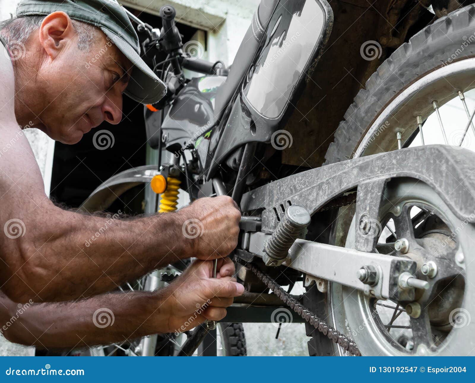 A Man Repairs a Broken Worn Motorcycle.. Stock Image - Image of ...